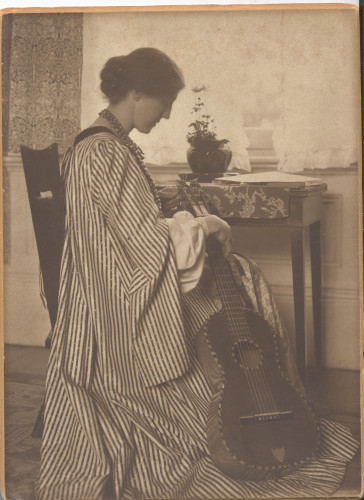 May Morris seated with guitar - William Morris Gallery